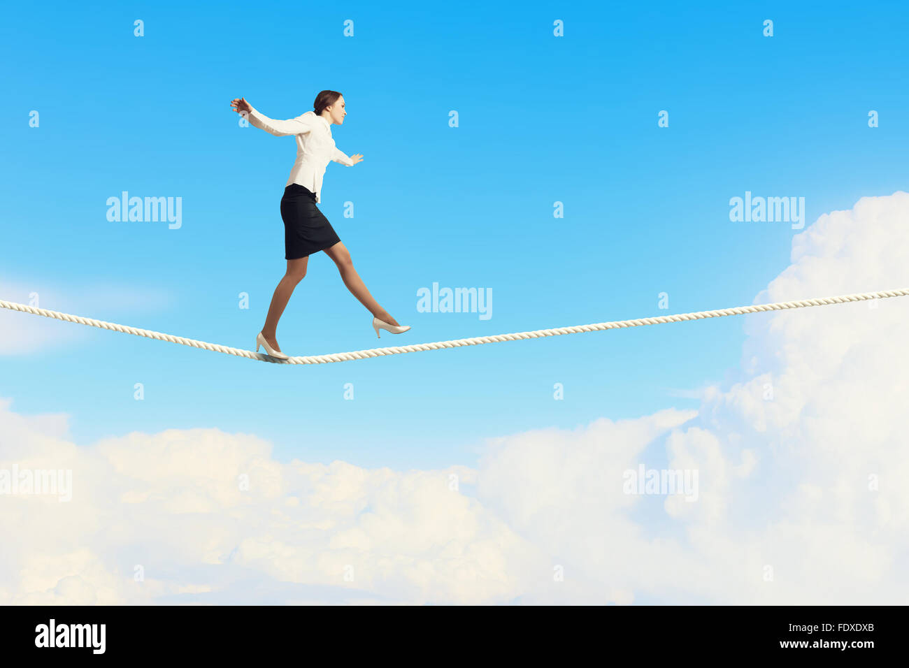 Image of businesswoman balancing on rope. Risk concept Stock Photo - Alamy