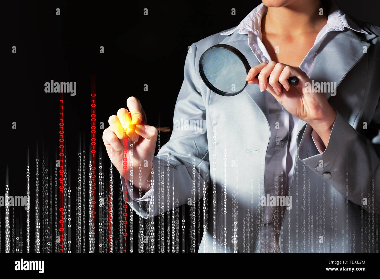 Businesswoman with magnifier glass examining binary code Stock Photo - Alamy