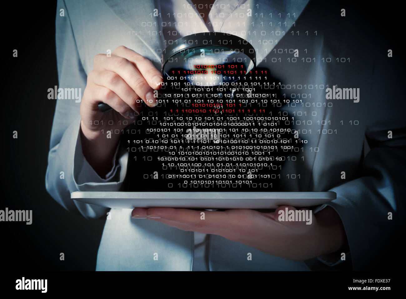 Businesswoman with magnifier glass examining binary code Stock Photo - Alamy