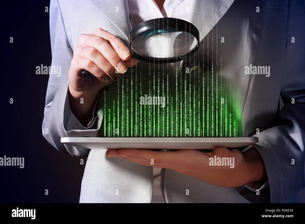 Businesswoman with magnifier glass examining binary code Stock Photo ...