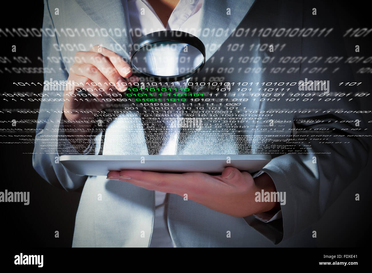 Businesswoman with magnifier glass examining binary code Stock Photo ...