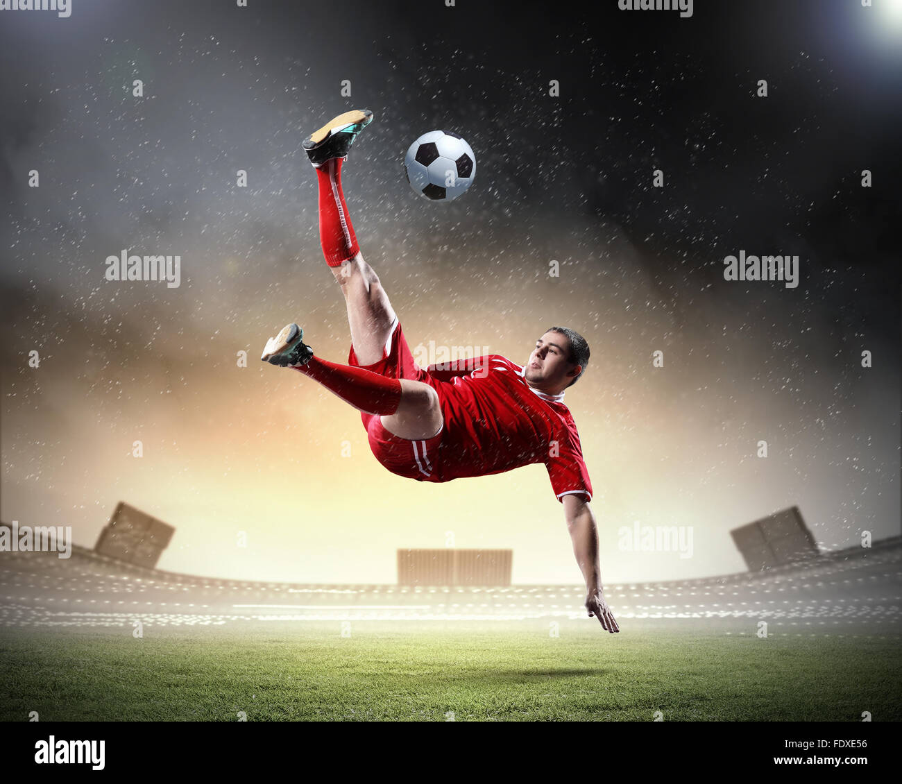 Image of football player at stadium hitting ball Stock Photo - Alamy