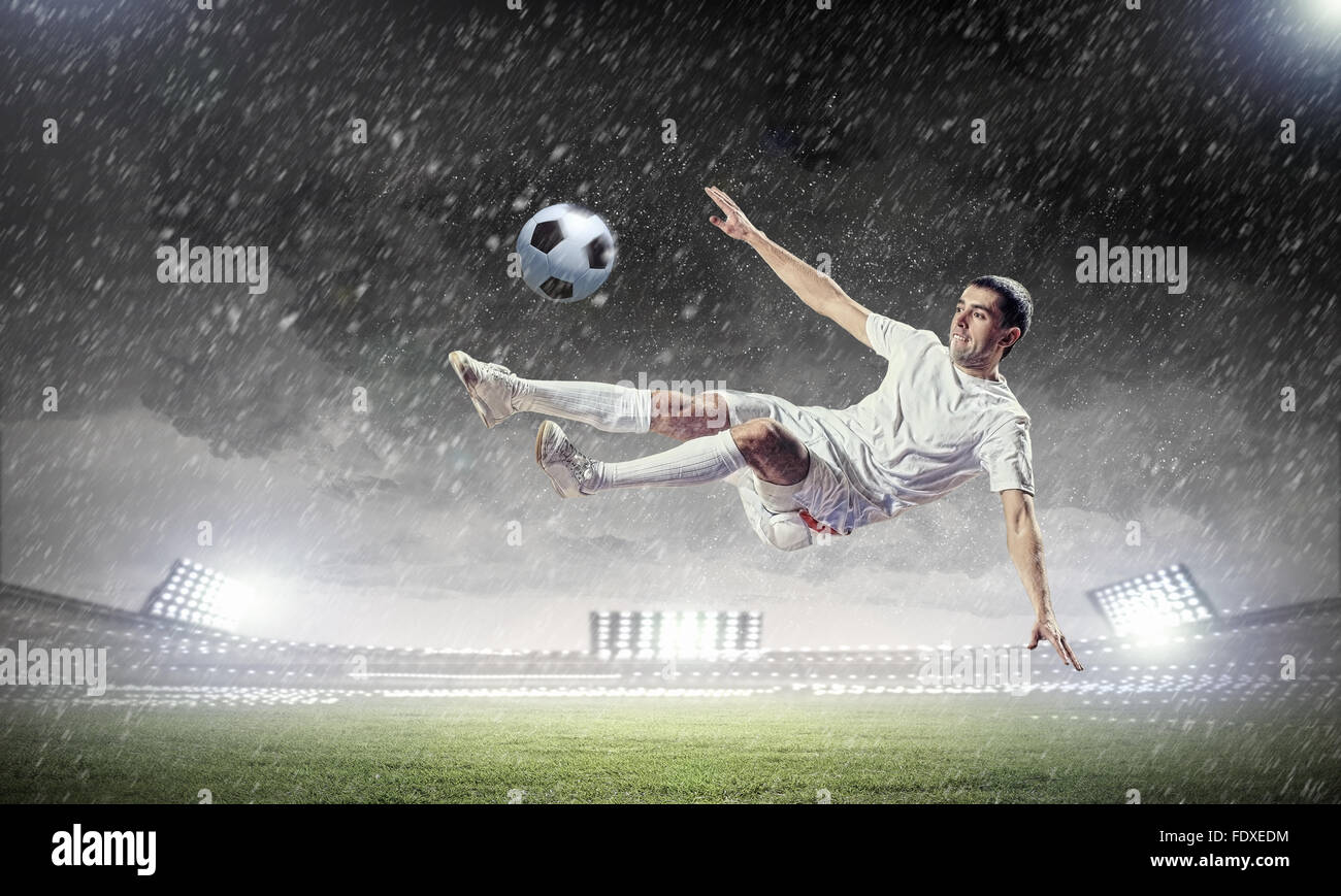 Image of football player at stadium hitting ball Stock Photo - Alamy