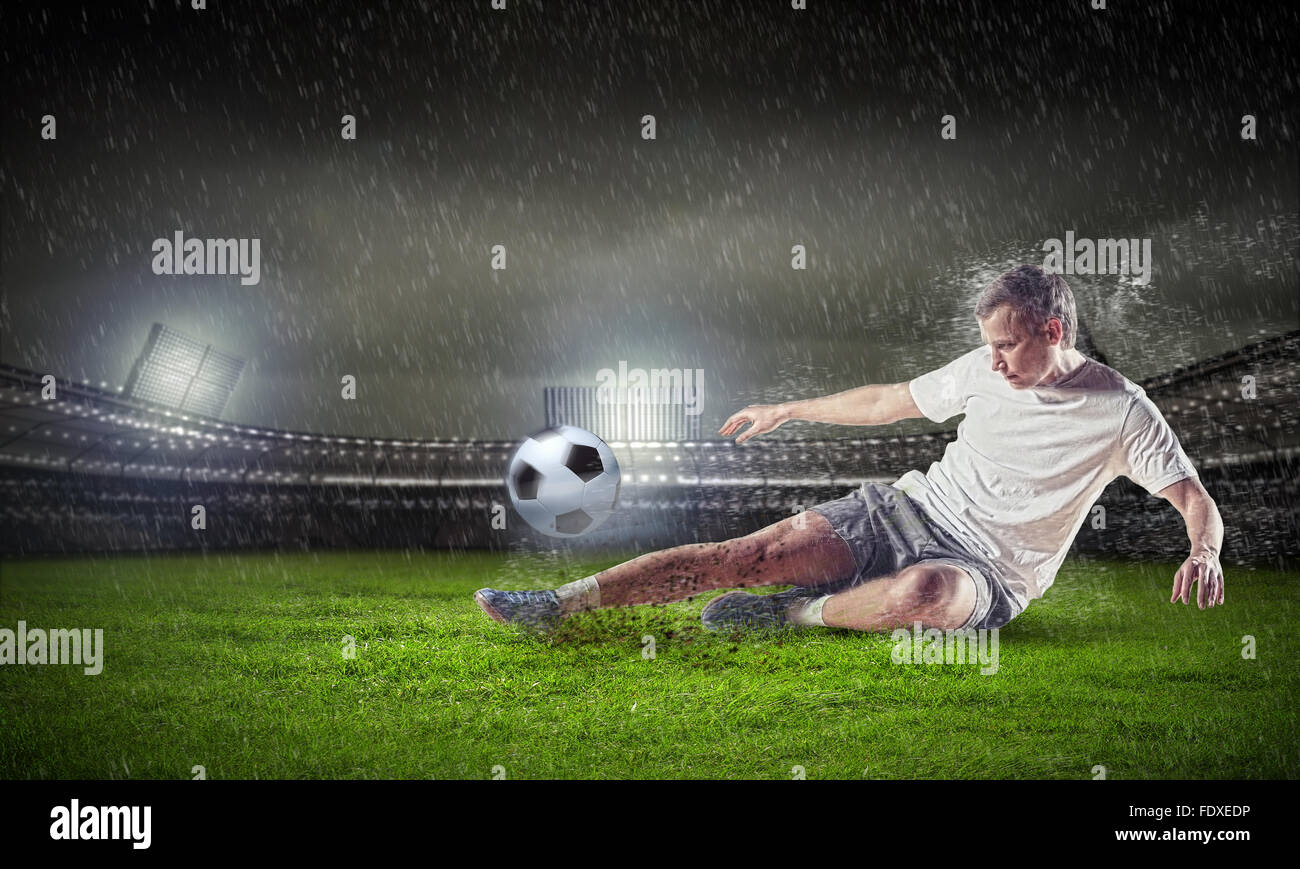 Image of football player at stadium hitting ball Stock Photo - Alamy