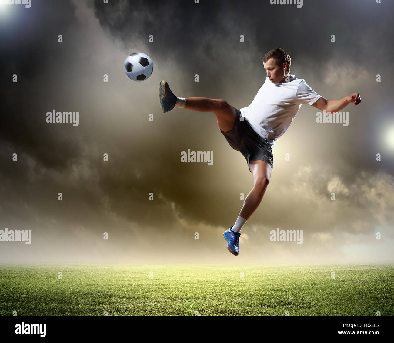 Image of football player at stadium hitting ball Stock Photo - Alamy