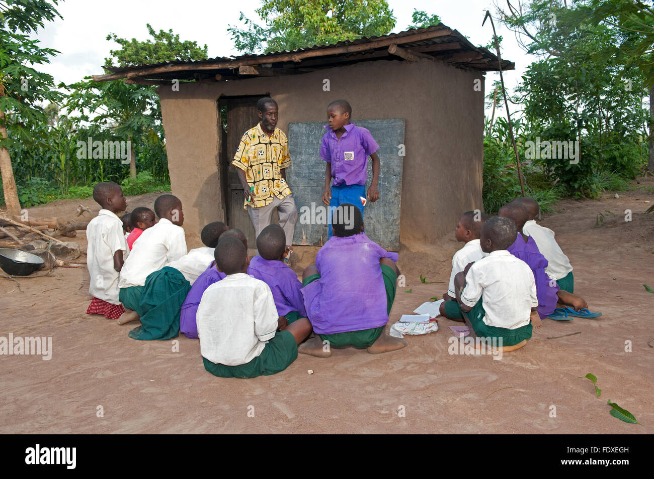 Children learning from a teacher at an outside classroom, Uganda Stock ...