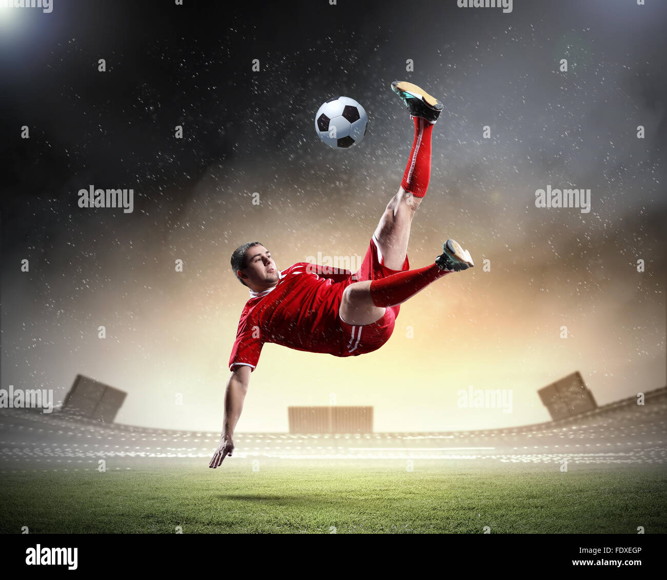 Image of football player at stadium hitting ball Stock Photo - Alamy