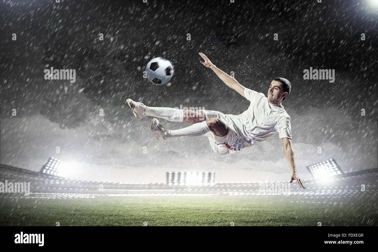 Image of football player at stadium hitting ball Stock Photo - Alamy