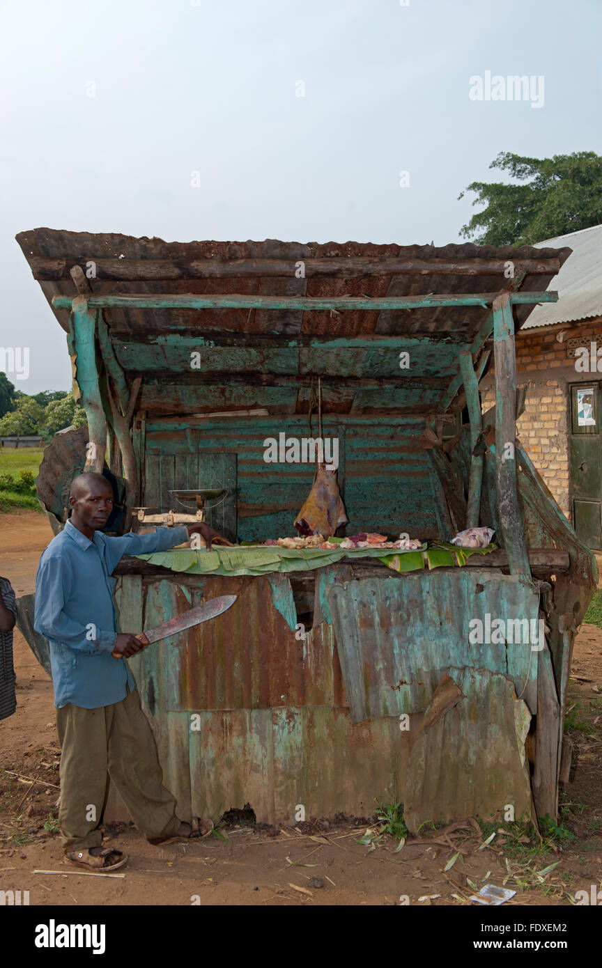 Ugandan butcher in his roadside shop made from tin sheets. Uganda Stock ...