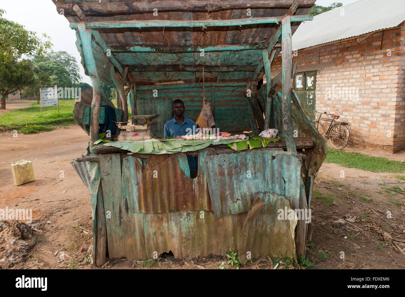 Ugandan butcher in his roadside shop made from tin sheets. Uganda Stock ...