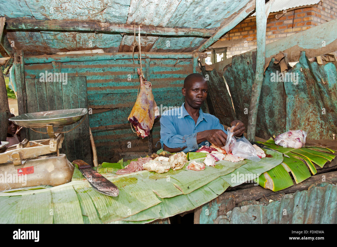 Ugandan butcher in his roadside shop made from tin sheets. Uganda Stock ...