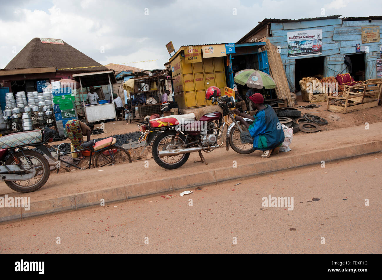 Roadside village scenes in rural Uganda, showing shops and stores along ...