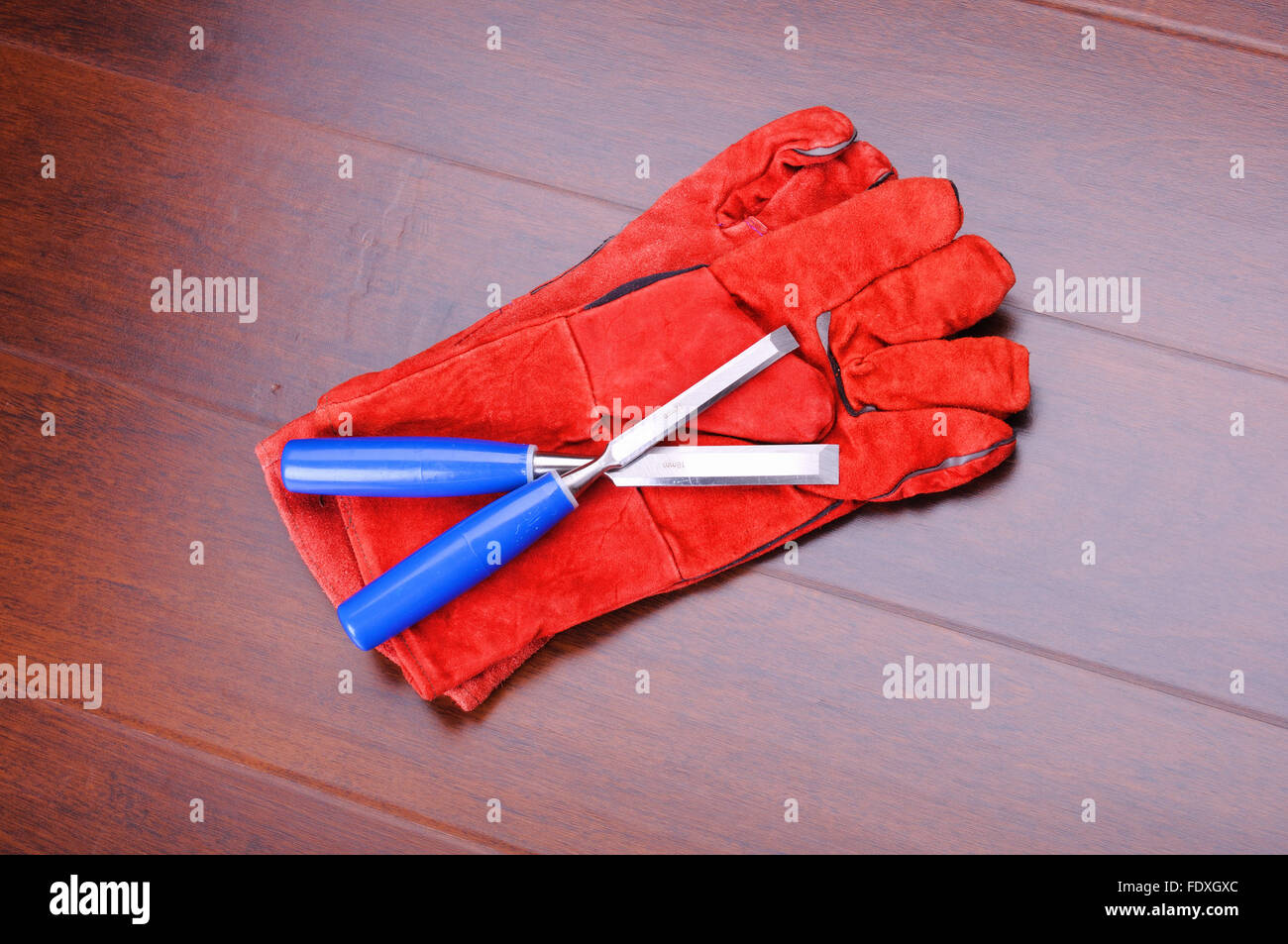 Gloves for working in red and blue tools Stock Photo - Alamy