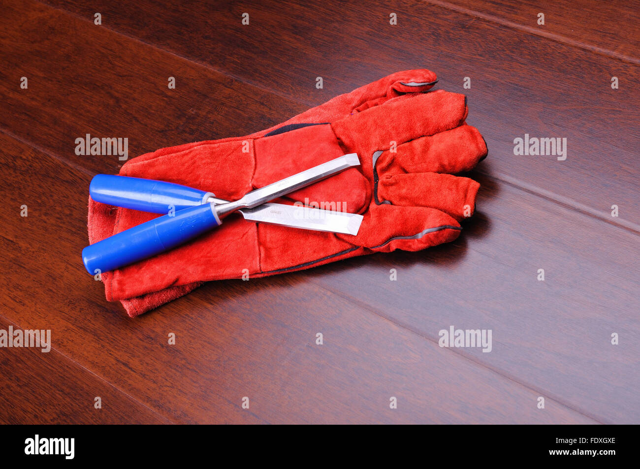 Gloves for working in red and blue tools Stock Photo - Alamy