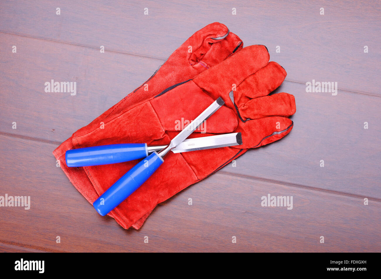 Gloves for working in red and blue tools Stock Photo - Alamy