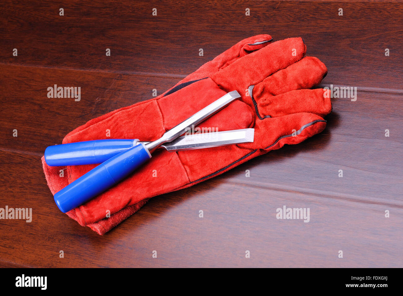Gloves for working in red and blue tools Stock Photo - Alamy