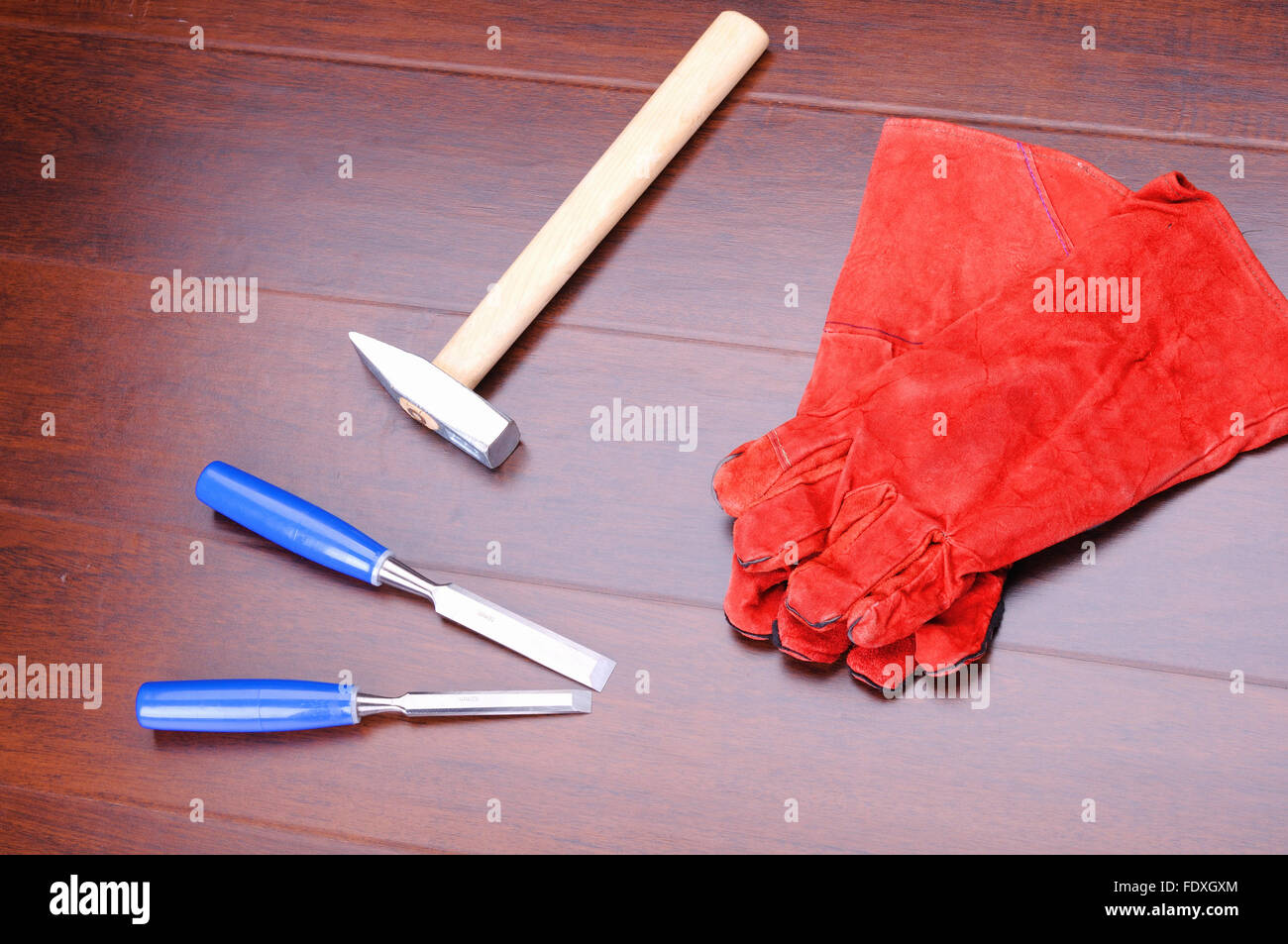 Gloves for working in red and blue tools Stock Photo - Alamy