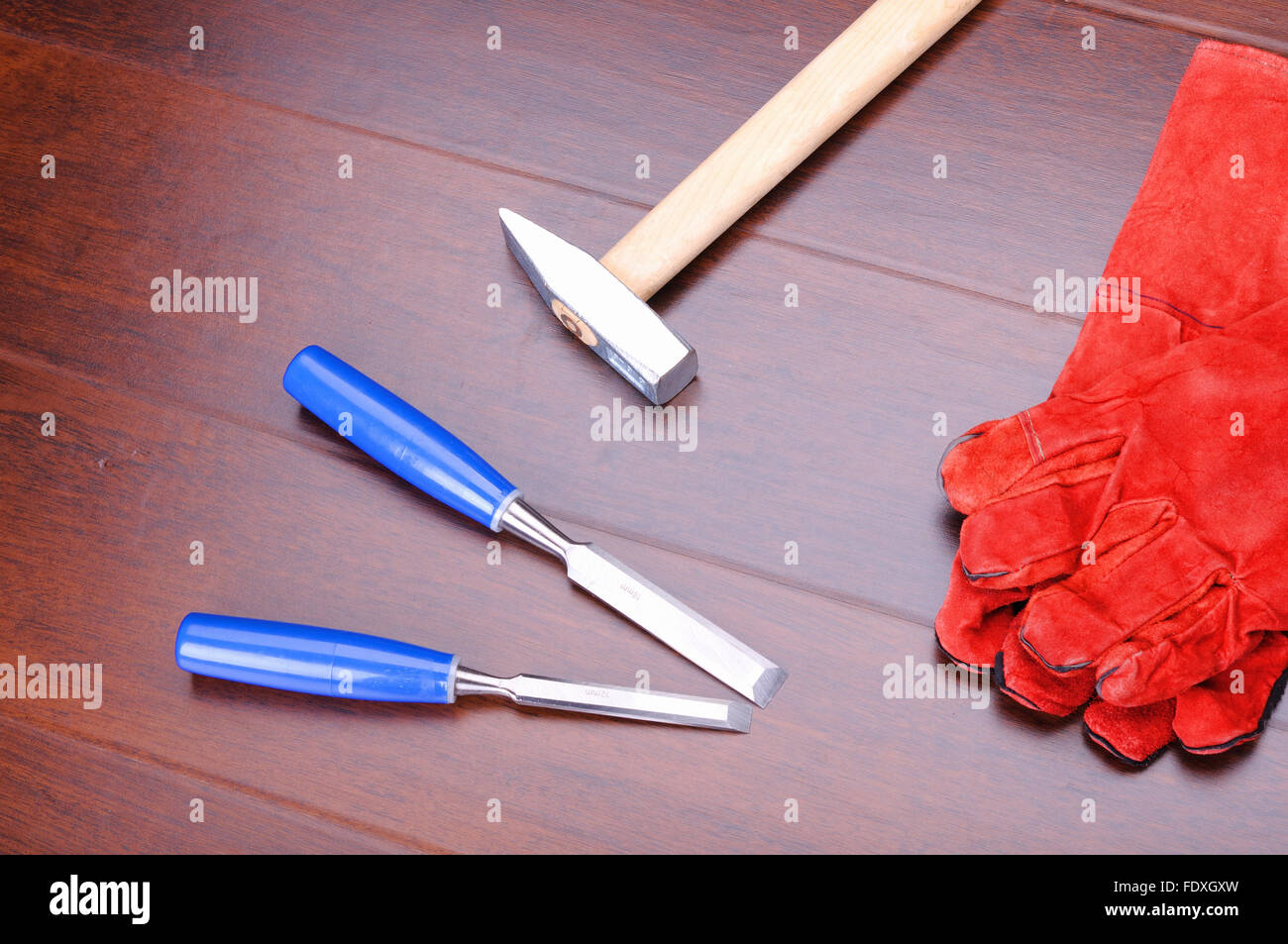 Gloves for working in red and blue tools Stock Photo - Alamy