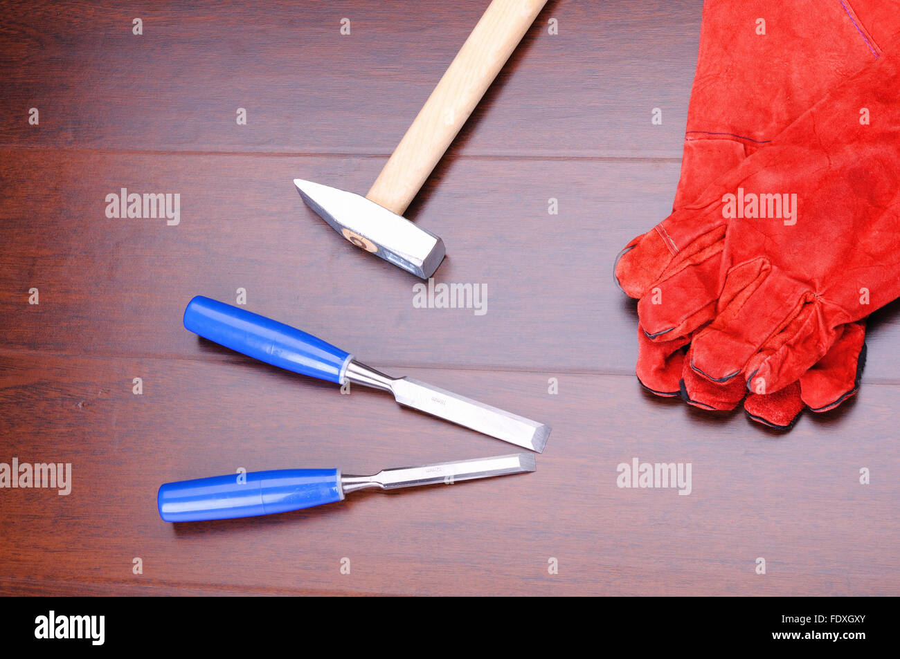 Gloves for working in red and blue tools Stock Photo - Alamy