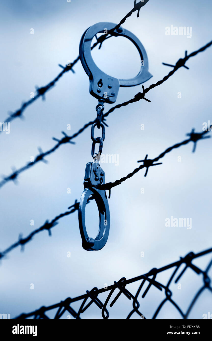 handcuffss and fence Stock Photo - Alamy