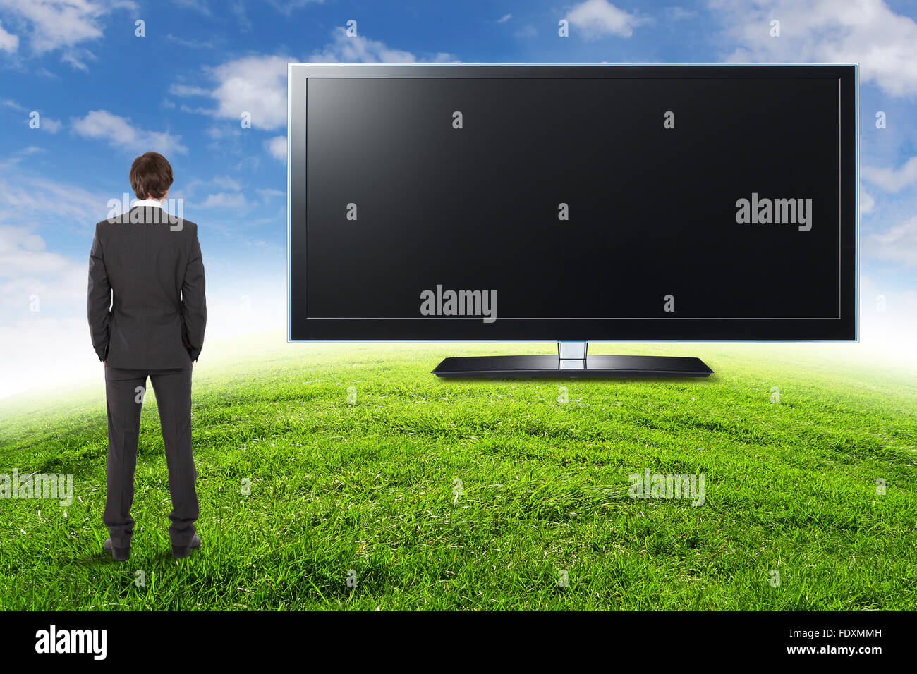 Business person standing near a blank billboard Stock Photo - Alamy