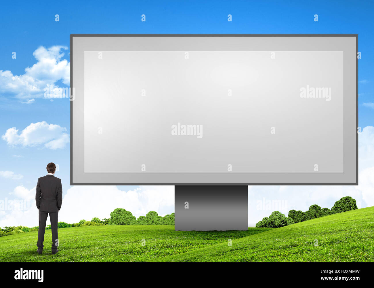 Business person standing near a blank billboard Stock Photo - Alamy