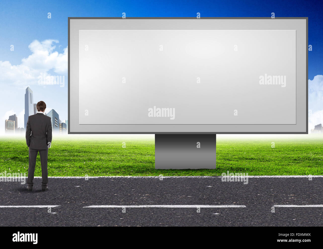 Business person standing near a blank billboard Stock Photo - Alamy