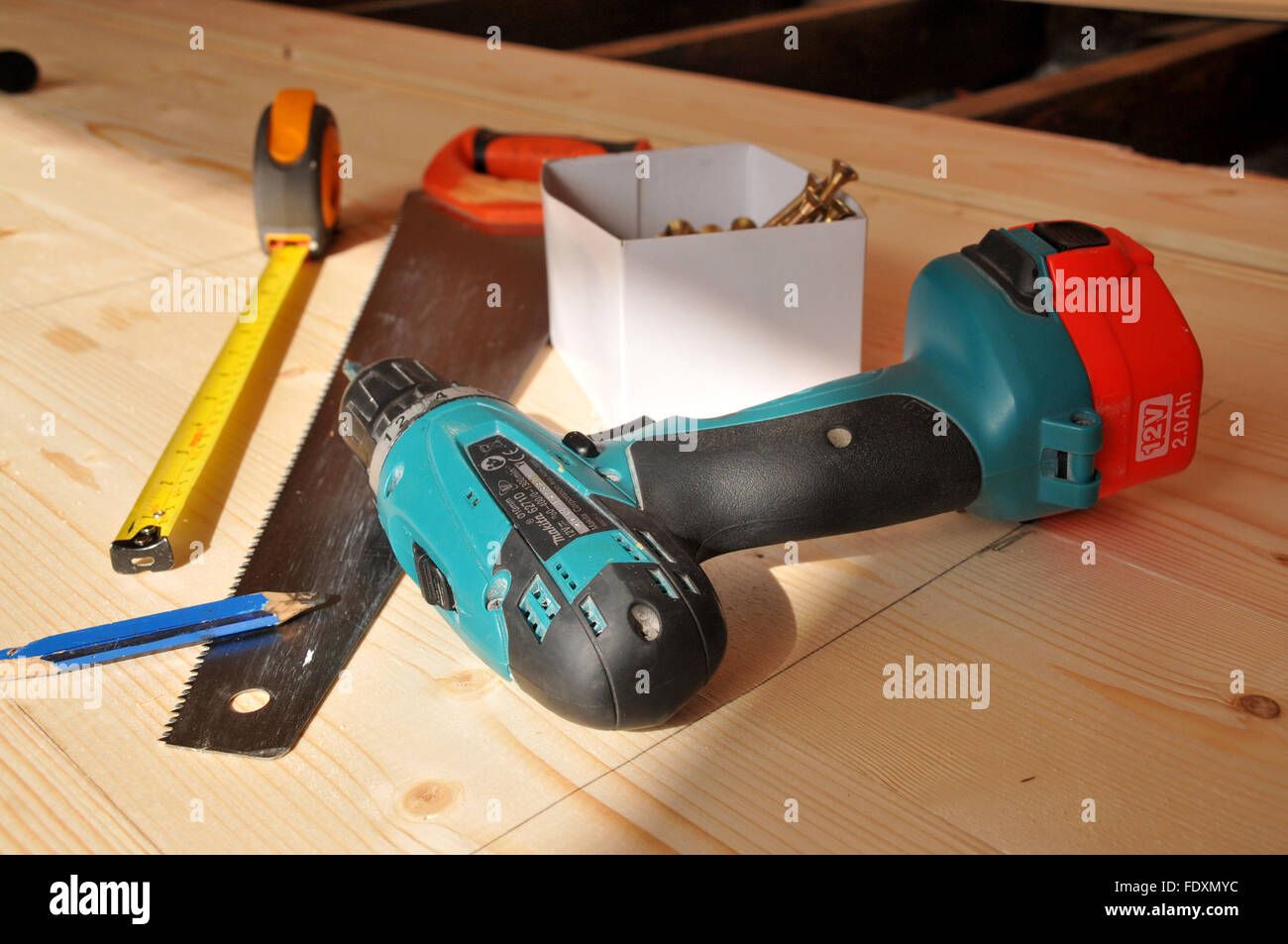 Joiners tools on new wooden floor - drill, hand saw, pencil, screws and ...