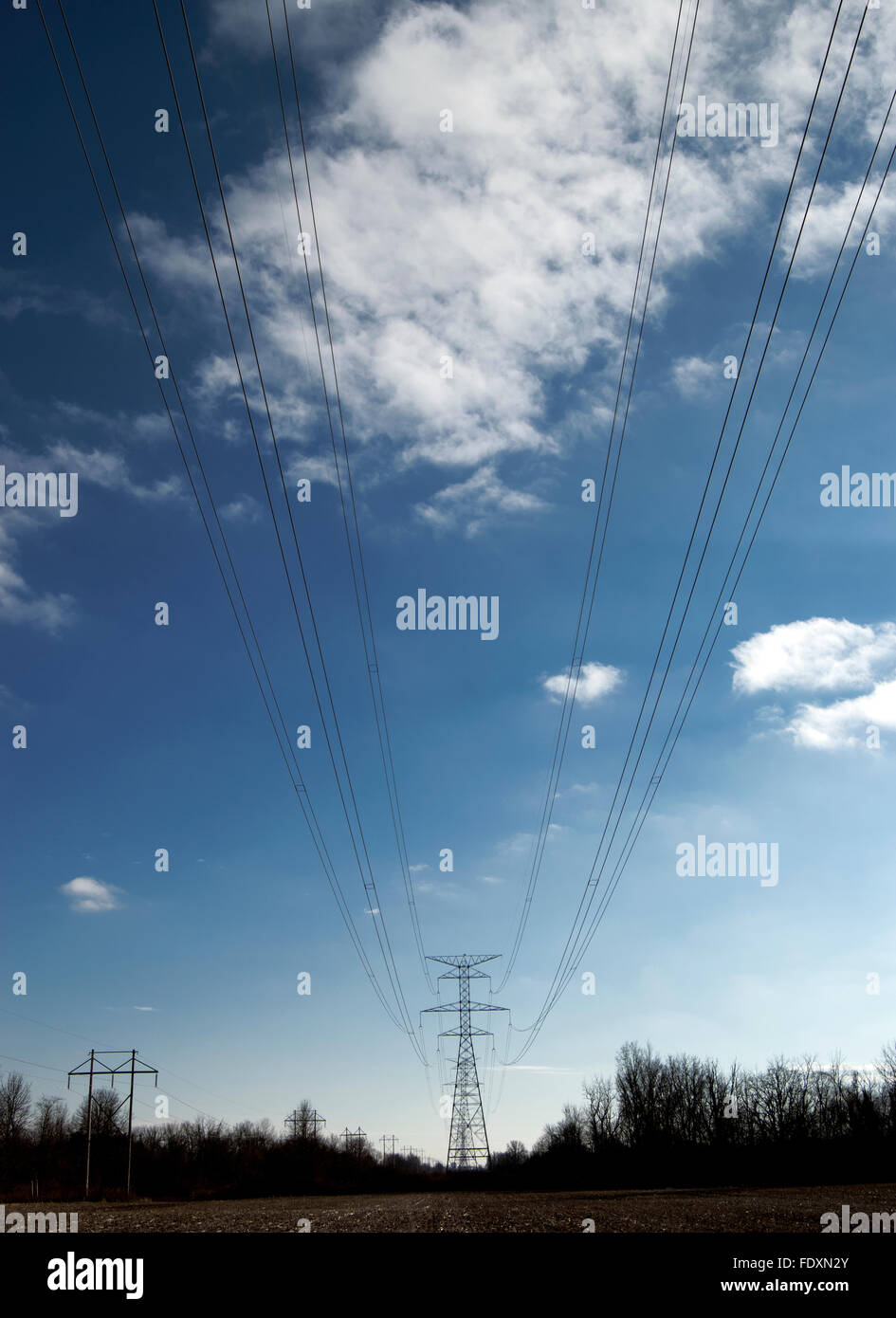 electrical power lines with blue sky and clouds Stock Photo - Alamy