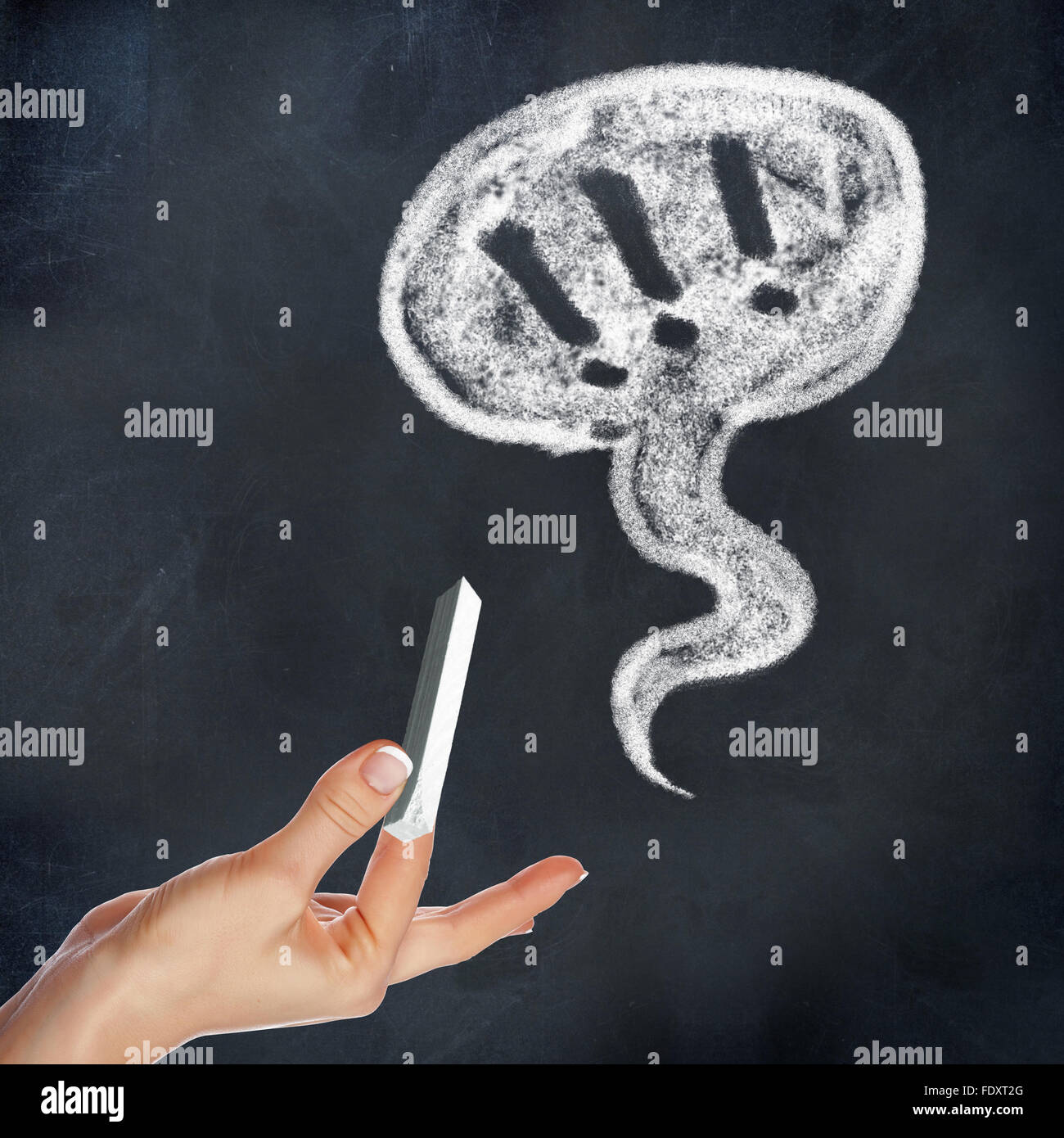 School blackboard and hand with chalk writing exclamation signs on it ...