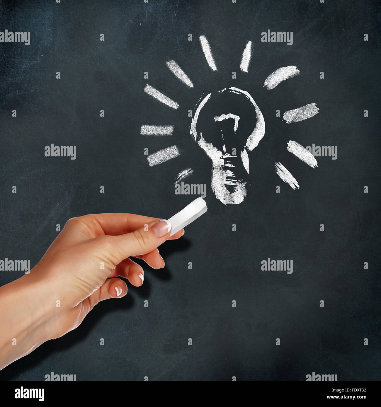 School blackboard and human hand drawing light bulb symbol Stock Photo ...