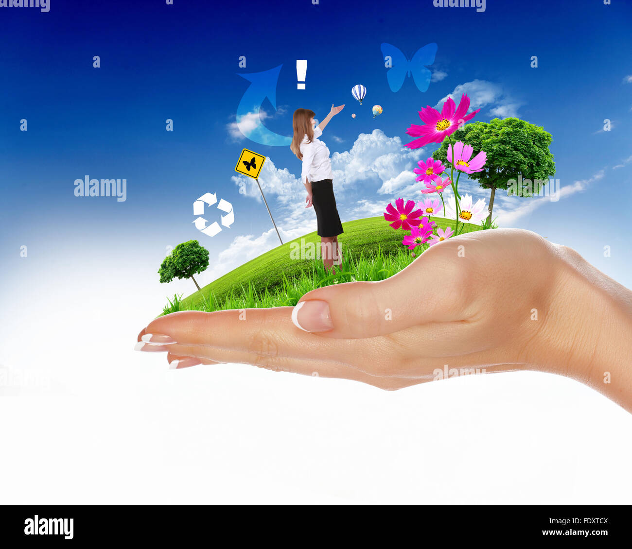 human hand holding a city on green grass hill Stock Photo - Alamy