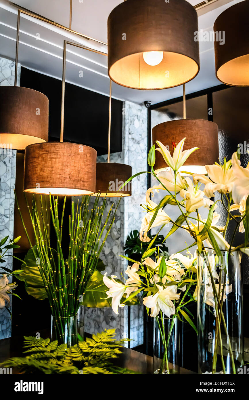 Hanging lights and lilies flower arrangements Stock Photo - Alamy