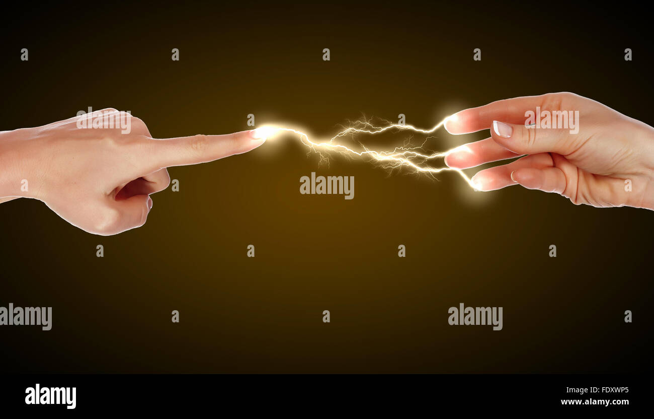 Two human hands in contact with bright flash Stock Photo - Alamy