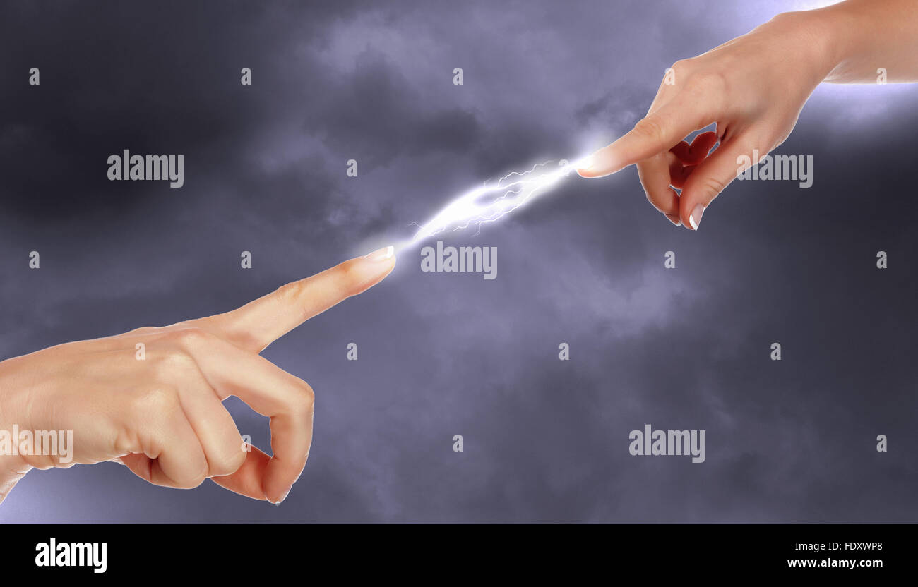 Two human hands in contact with bright flash Stock Photo - Alamy