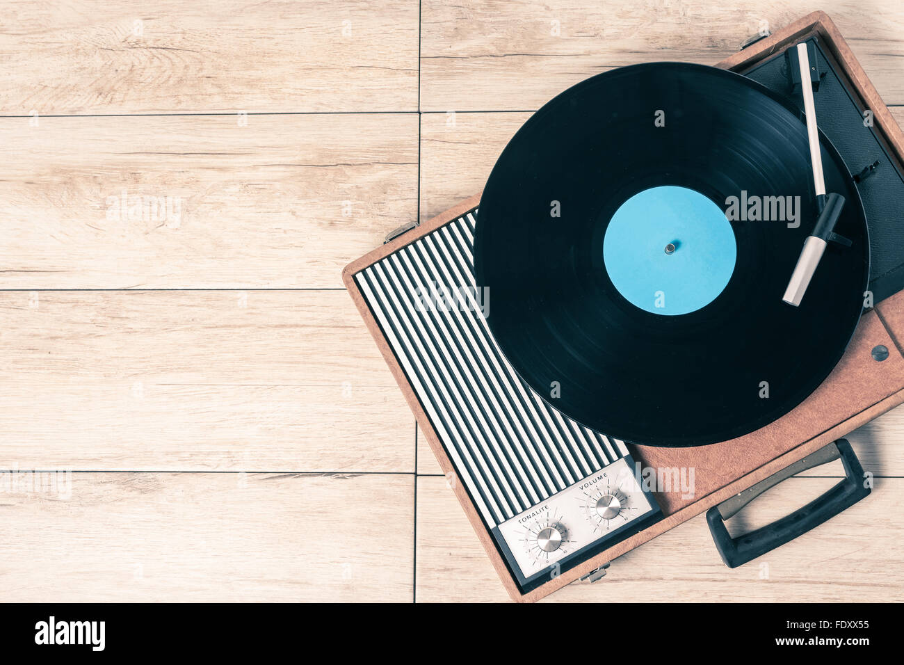 Gramophone with a vinyl record on wooden table, top view and copy space ...
