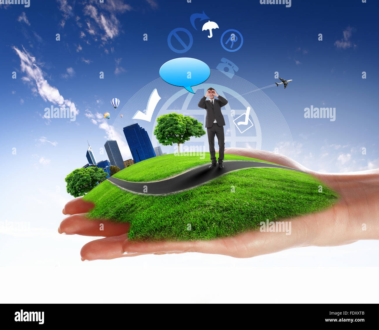 human hand holding a city on green grass hill Stock Photo - Alamy