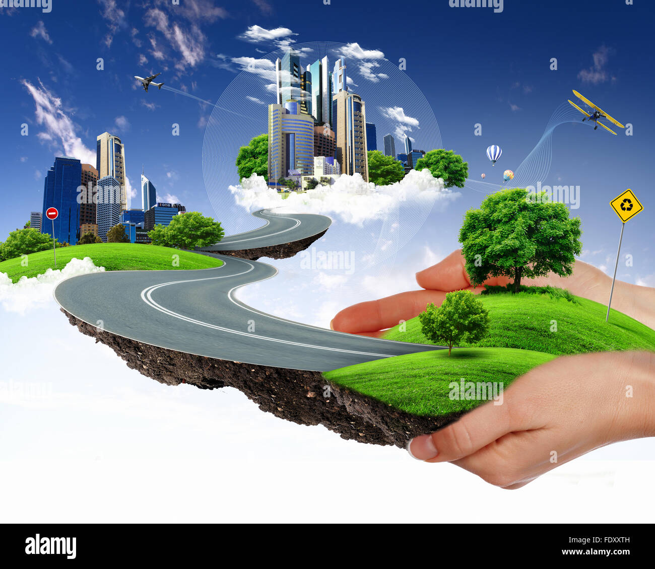 human hand holding a city on green grass hill Stock Photo - Alamy