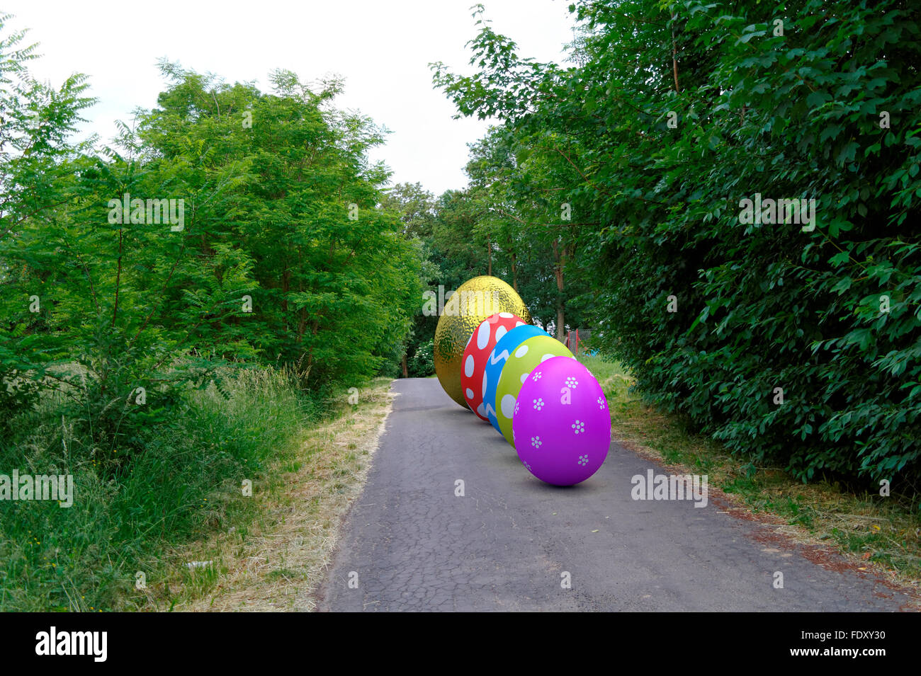 colorful easter eggs in single line on the country road Stock Photo - Alamy