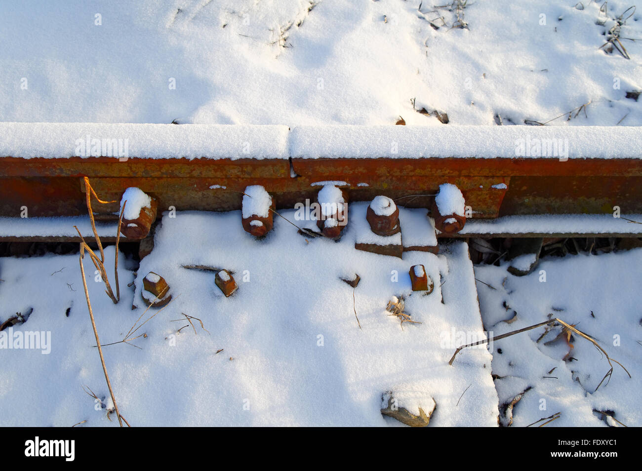 closeup of snow covered rusty iron rails connection Stock Photo - Alamy