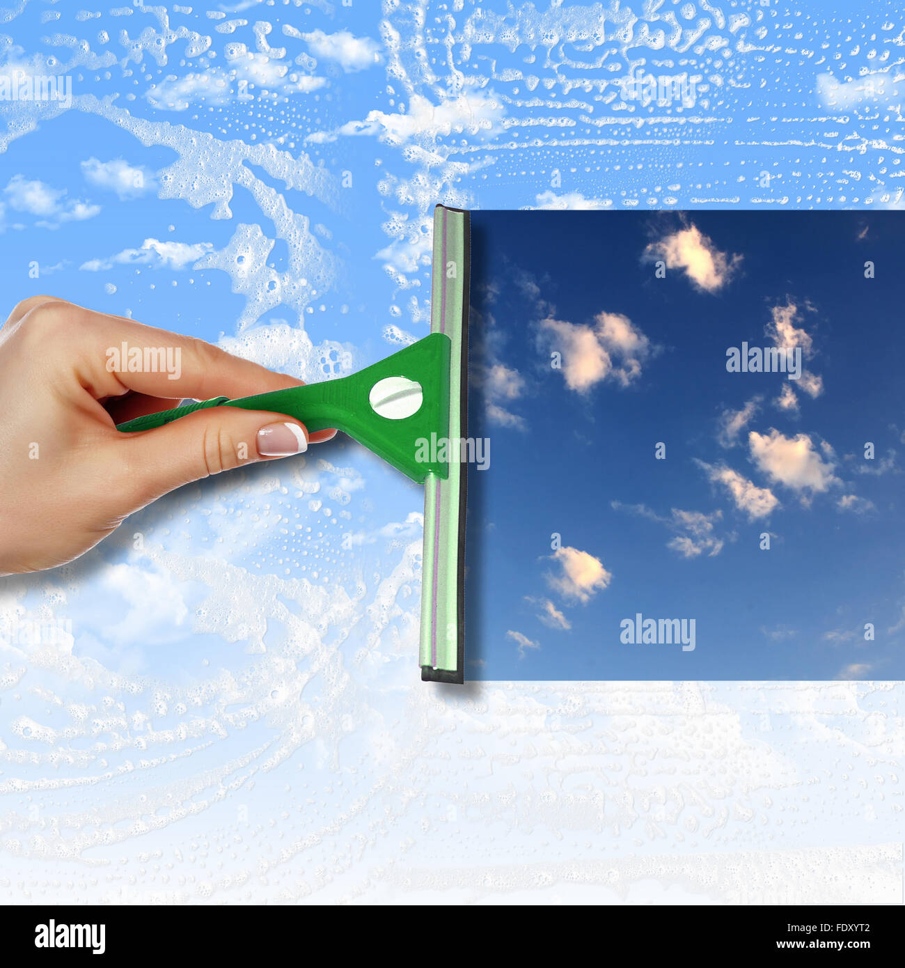 Hand cleaning window with blue sky and white clouds Stock Photo - Alamy