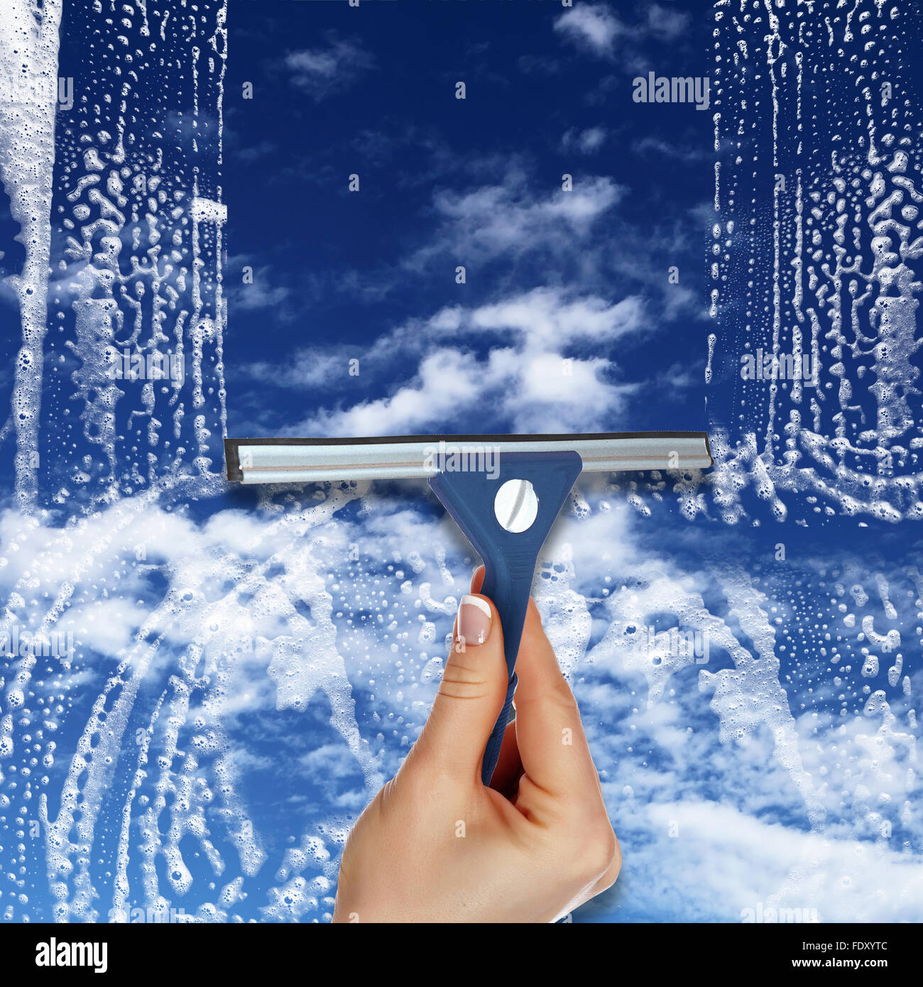 Hand cleaning window with blue sky and white clouds Stock Photo - Alamy