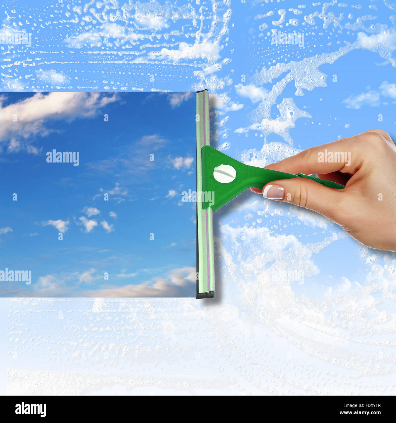 Hand cleaning window with blue sky and white clouds Stock Photo - Alamy