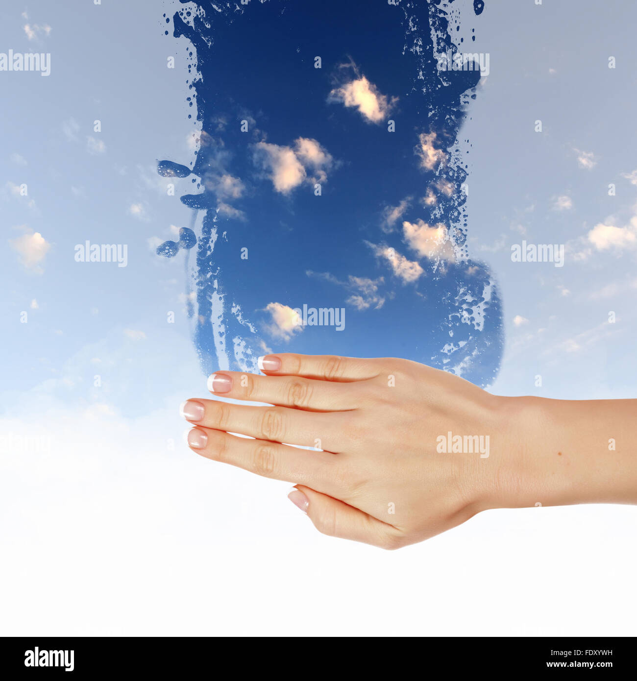 Hand cleaning window with blue sky and white clouds Stock Photo - Alamy