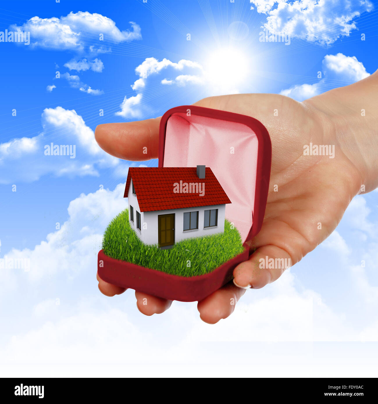 The House in the hands against the blue sky as a symbol of the real ...