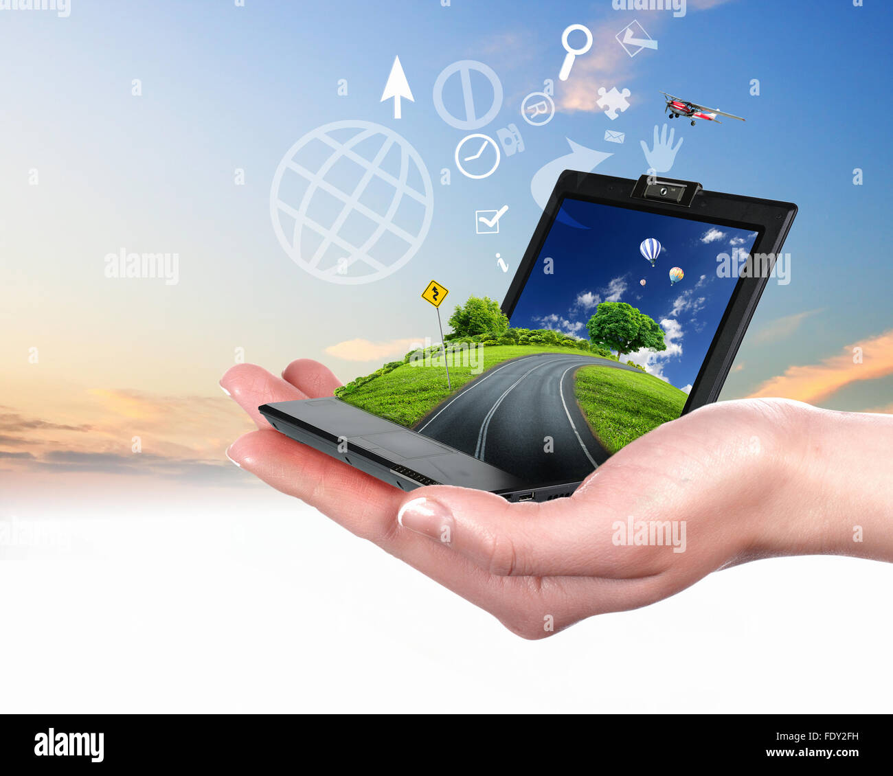 Collage with a human hand holding a green landscape Stock Photo - Alamy