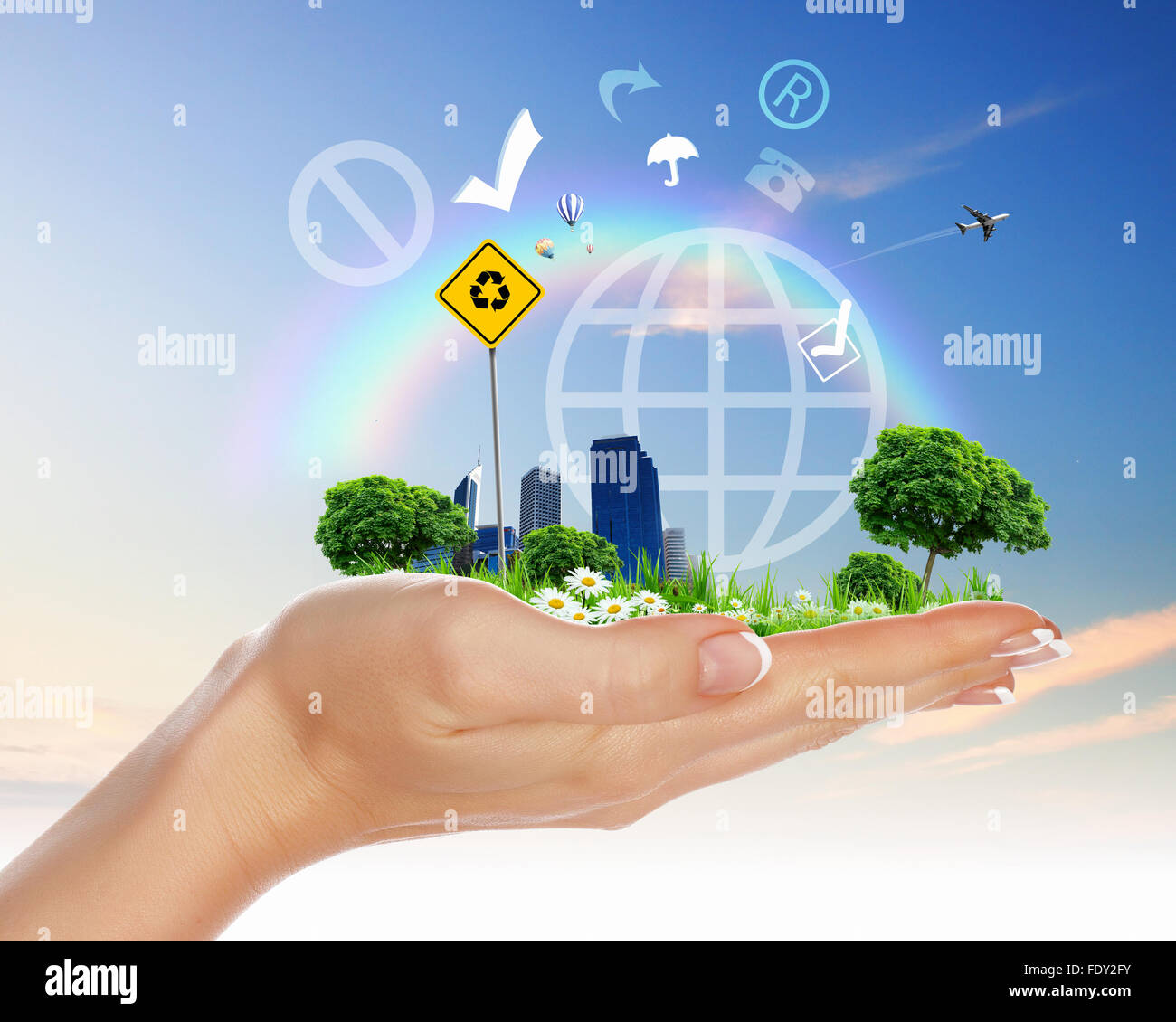 Collage with a human hand holding a green landscape Stock Photo - Alamy