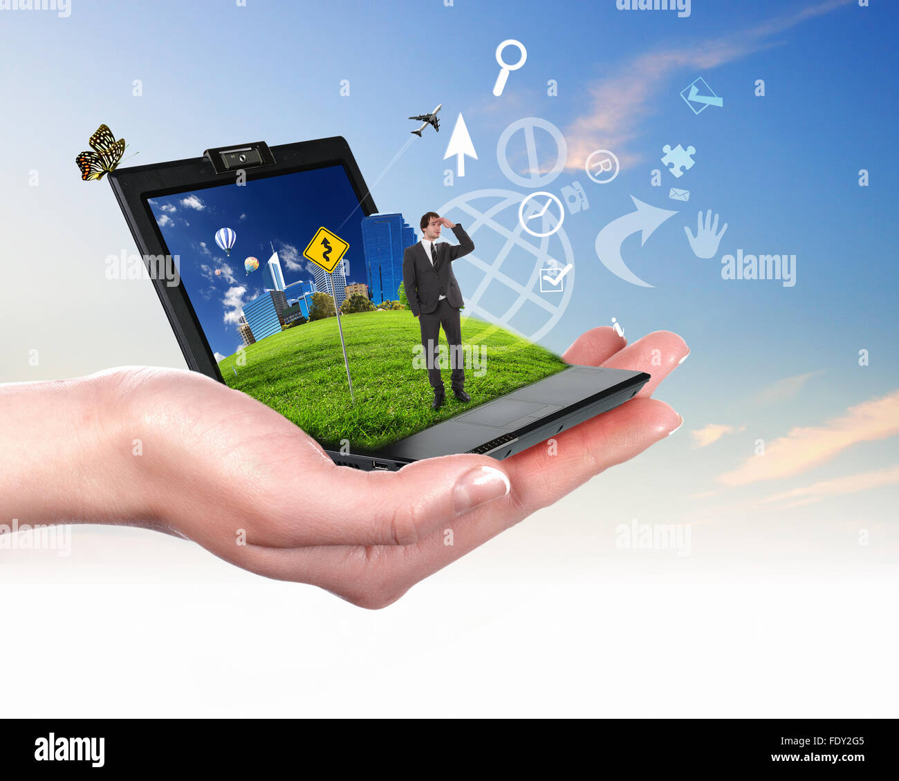 Collage with a human hand holding a green landscape Stock Photo - Alamy