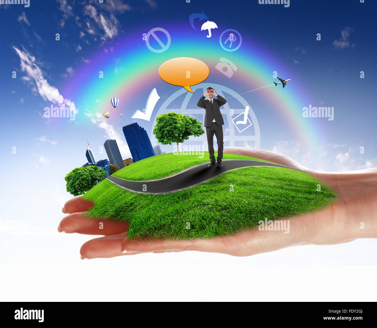 Collage with a human hand holding a green landscape Stock Photo - Alamy
