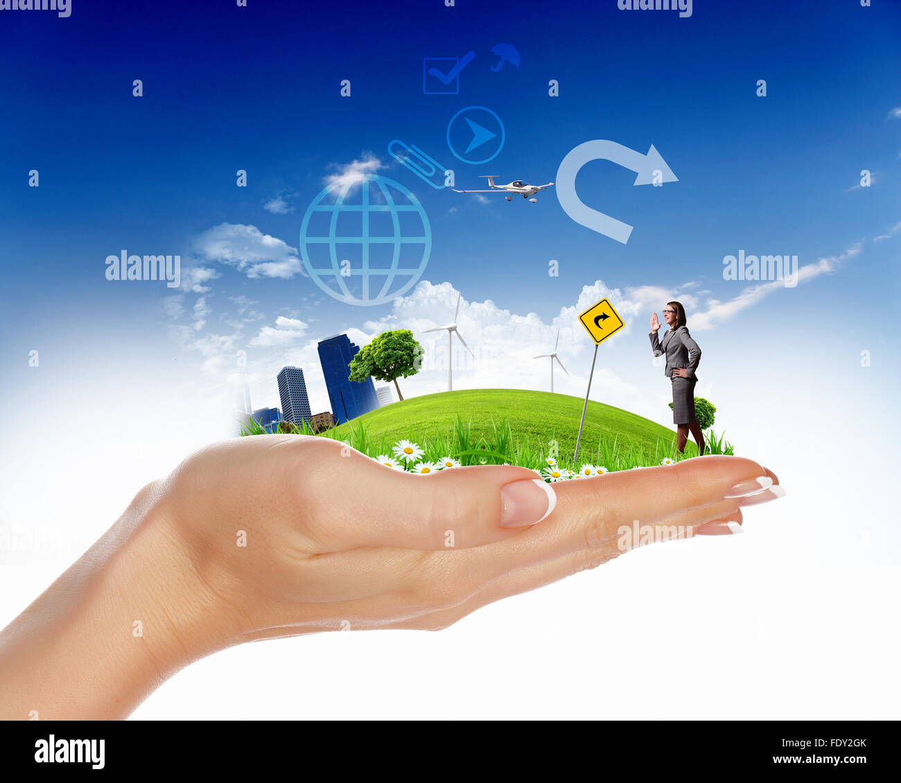 Collage with a human hand holding a green landscape Stock Photo - Alamy